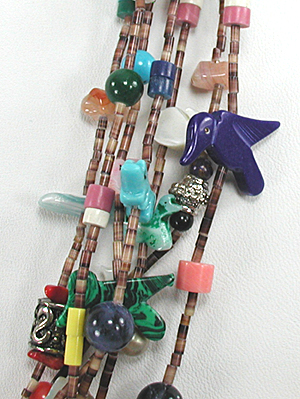 Seven strand treasure necklace 26 inches long with faux squaw wrap